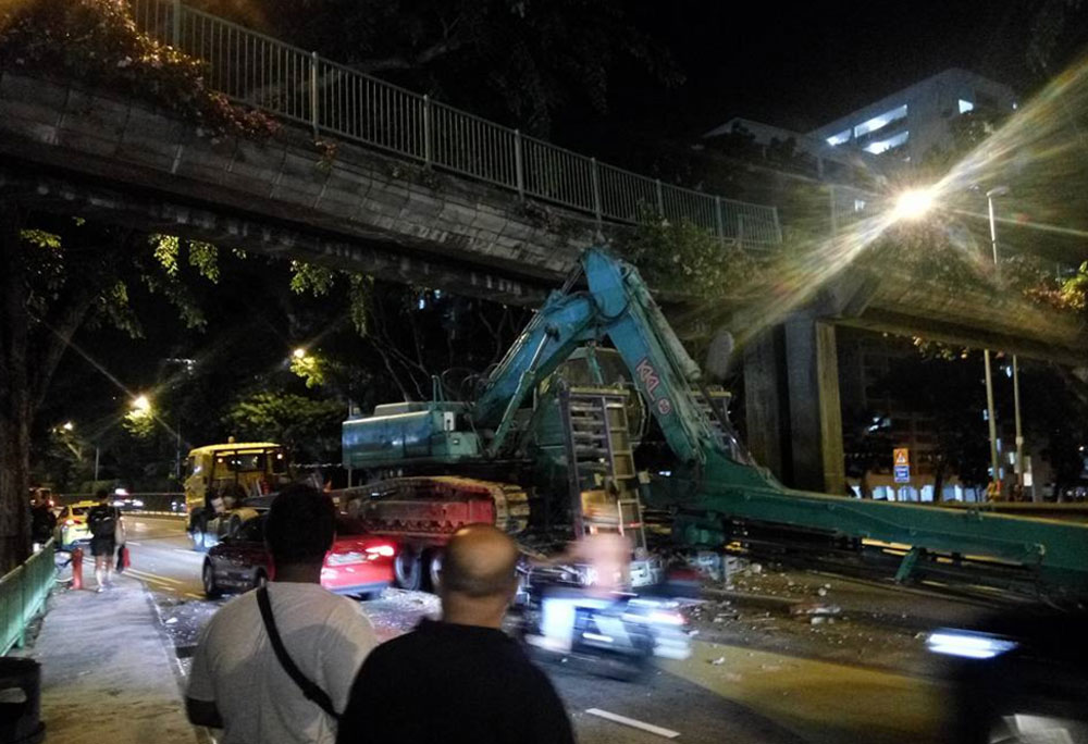 Excavator transported on trailer hits overhead bridge across Balestier ...