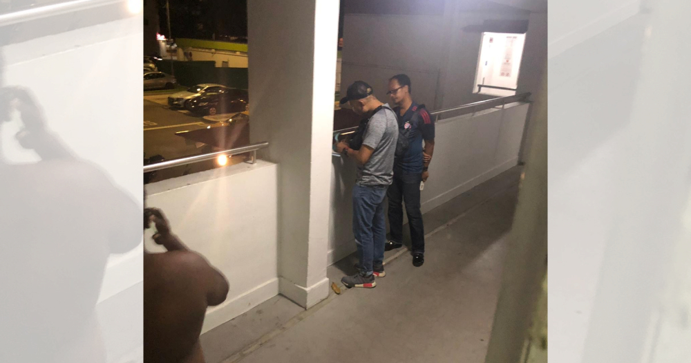 Resident caught smoking along HDB corridor by NEA enforcement officer ...